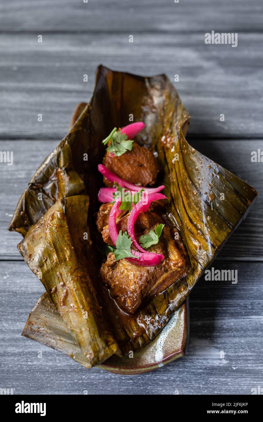 From above Mexican cochinita pibil dish made of pieces of pork baked in ...