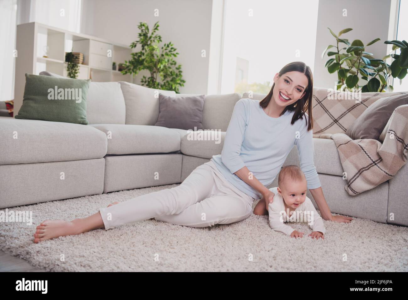 Full body photo of pretty positive girl adorable toddler sitting carpet ...