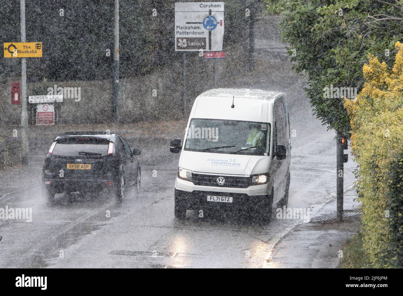 Chippenham, UK, 30th June, 2022. Car drivers are pictured braving heavy ...