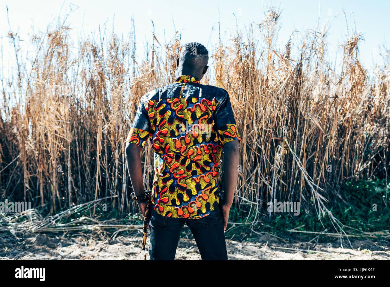 Back view of ethnic man wearing native African clothing and accessories ...
