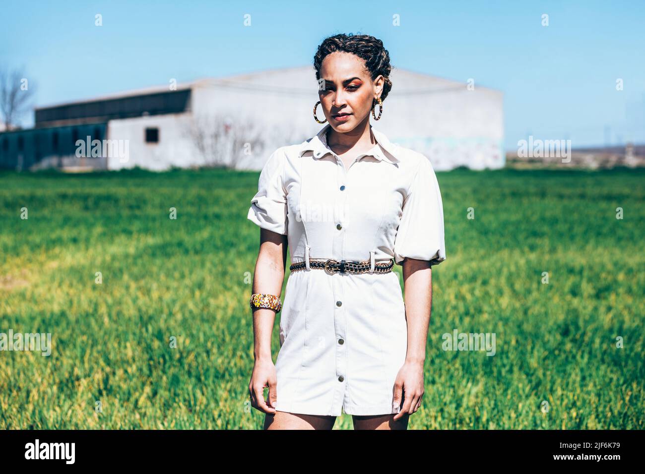 Trendy ethnic female model in casual white dress with traditional ...