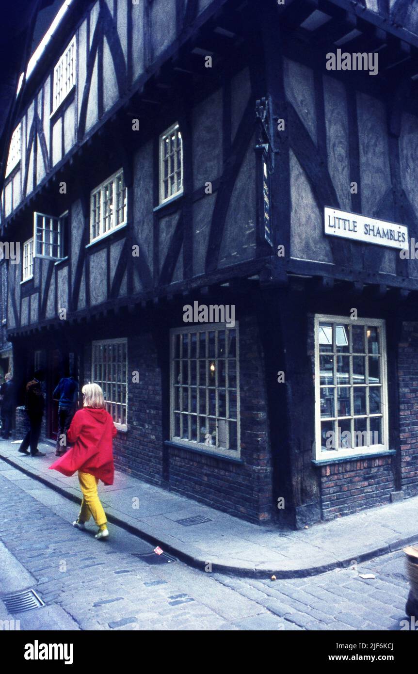 Colourfully-dressed blonde Woman in The Shambles an old street in York ...