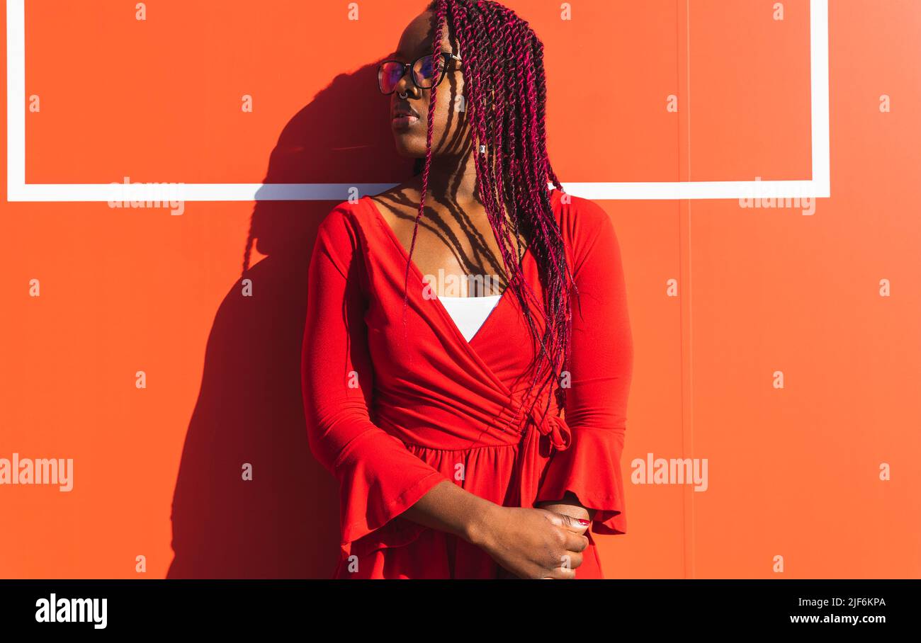 Portrait of young African American Woman in braids and trendy outfit ...