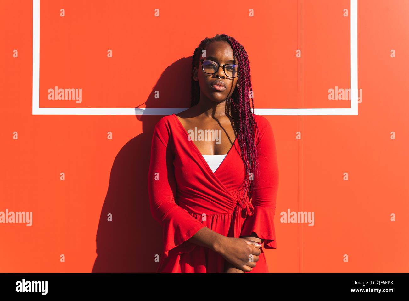 Portrait of young African American Woman in braids and trendy outfit ...