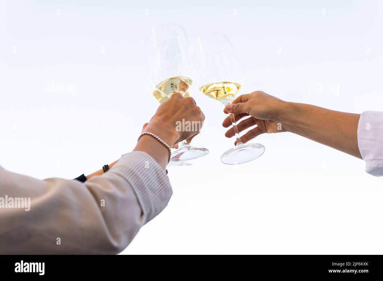 Cropped unrecognizable adult girlfriends in smart casual clothes ...