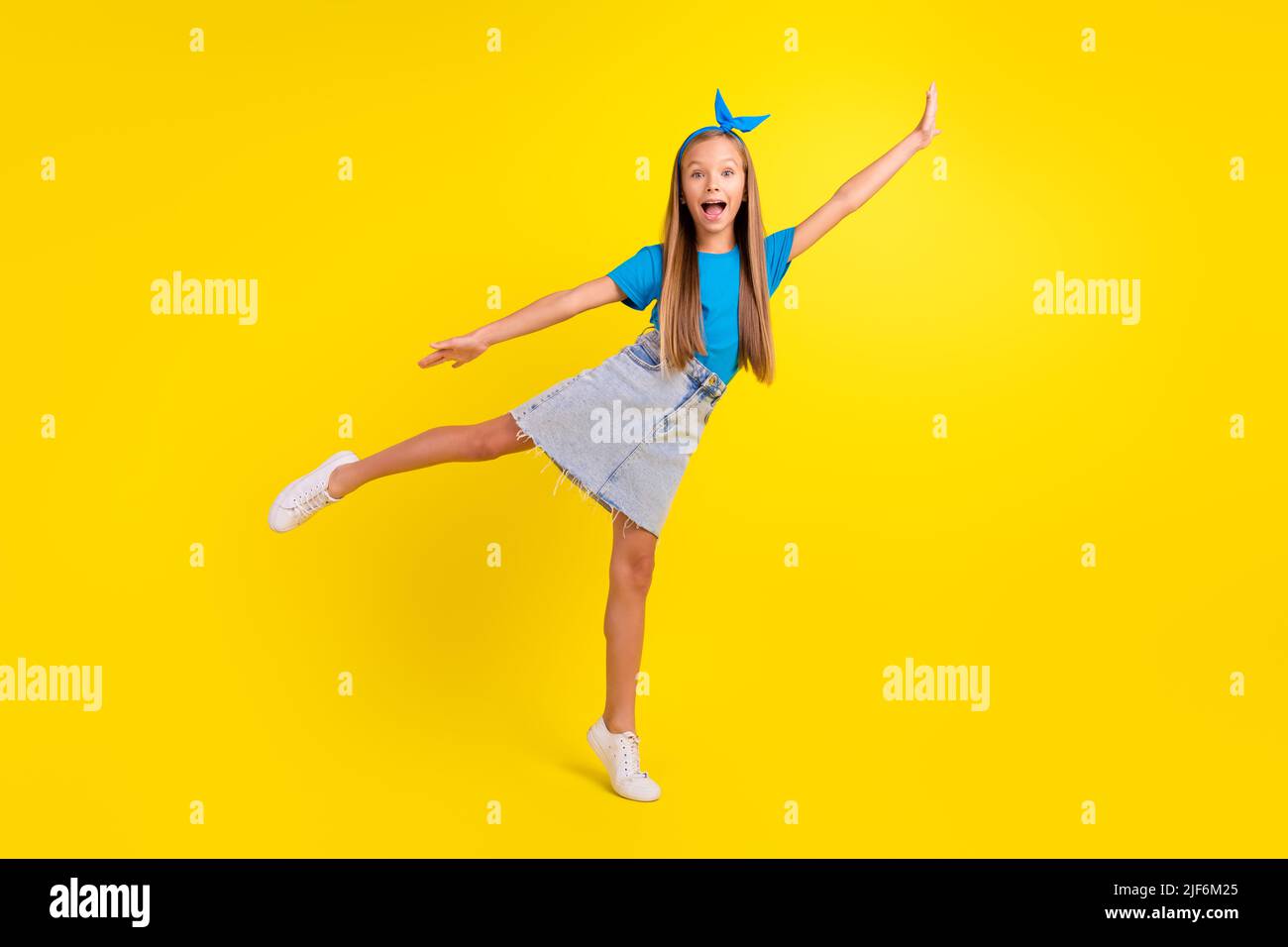 Full length photo of positive excited pupil stand one leg tip toe raise ...