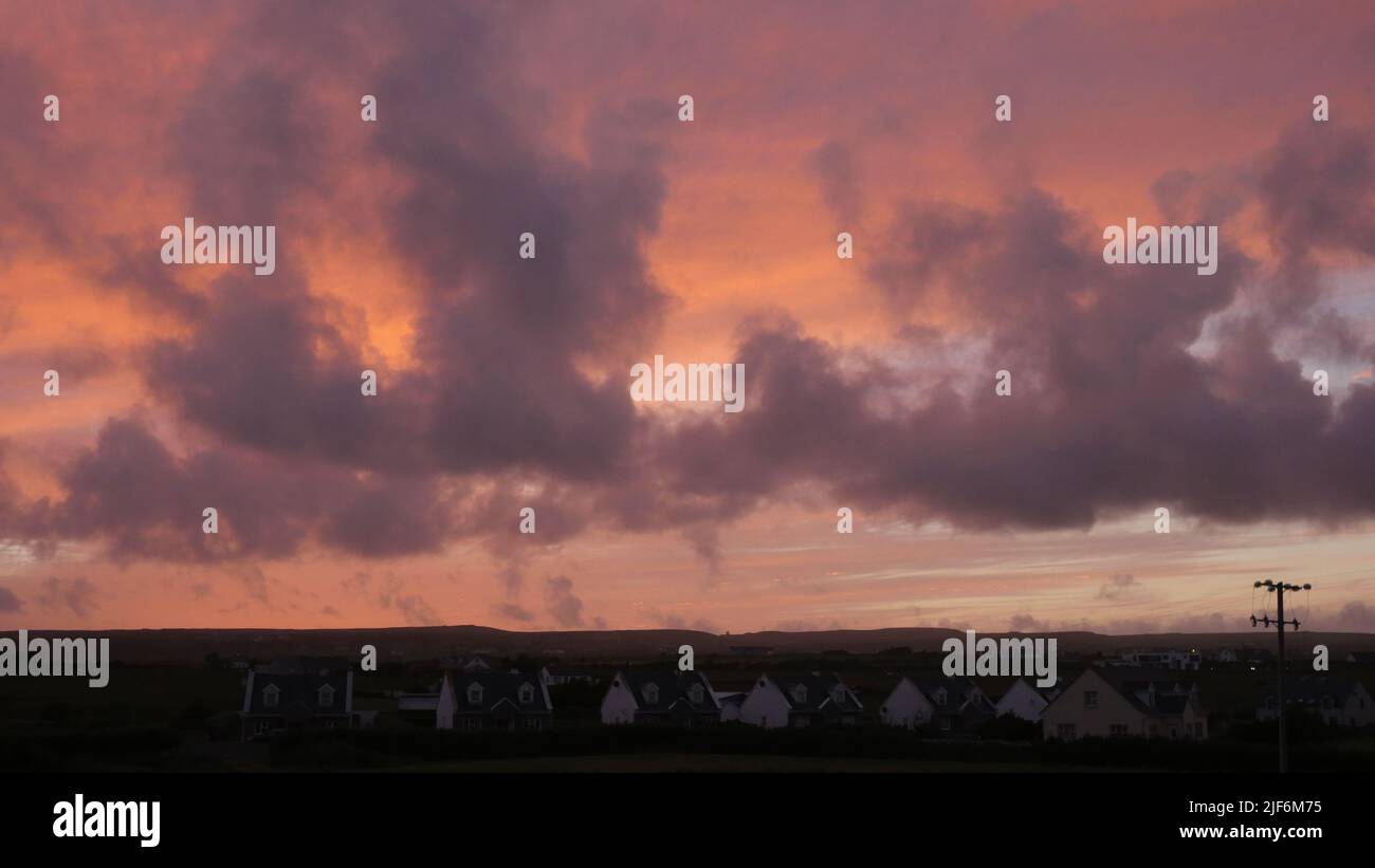 Clouds in a giant sky along the back of the cliffs of Moher in Ireland ...