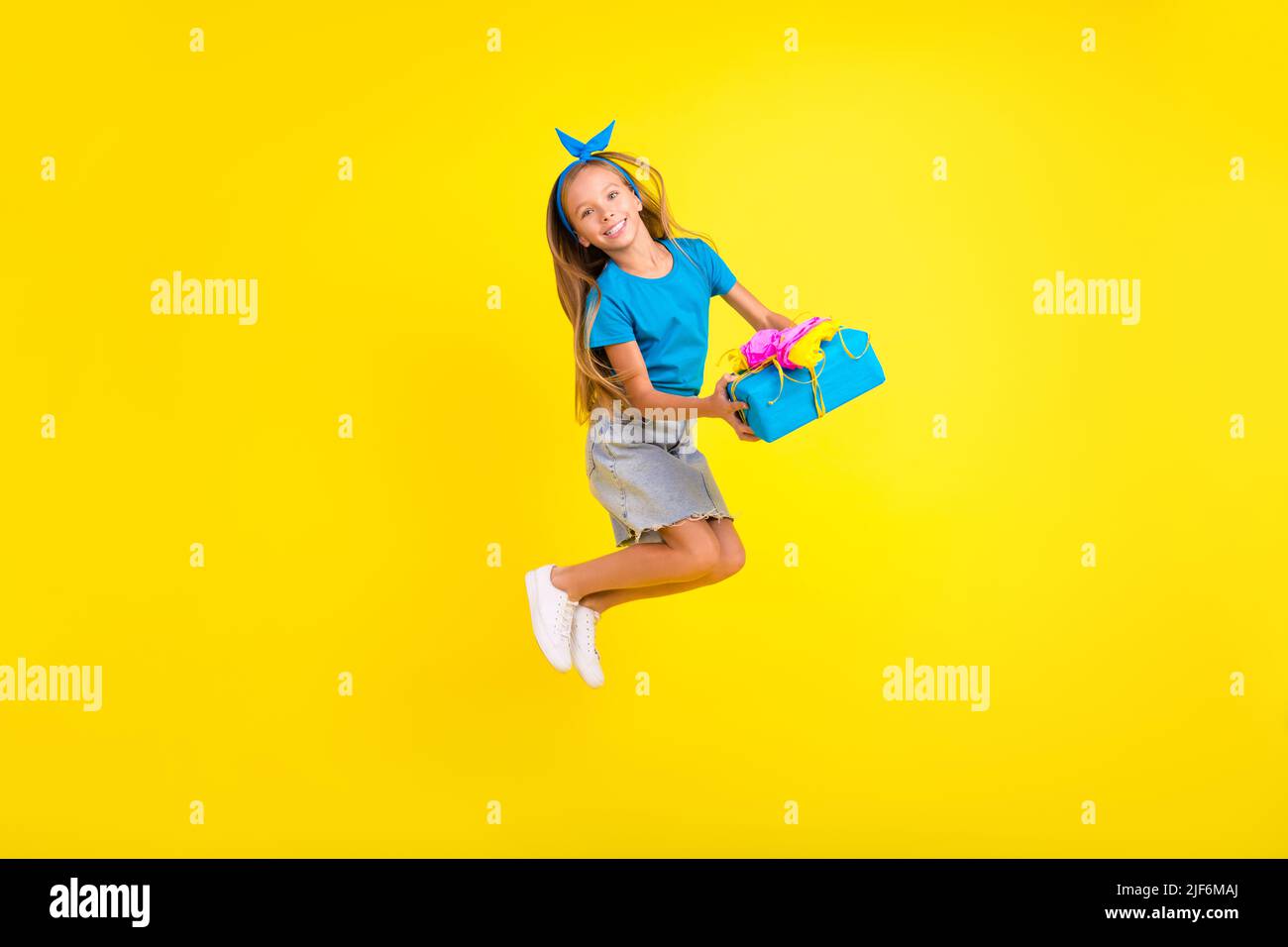 Full length portrait of excited overjoyed girl jump hands hold giftbox ...