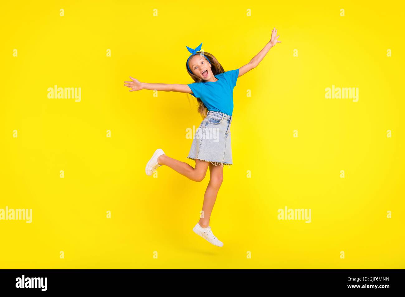 Full length photo of excited crazy girl jump have fun raise hands ...