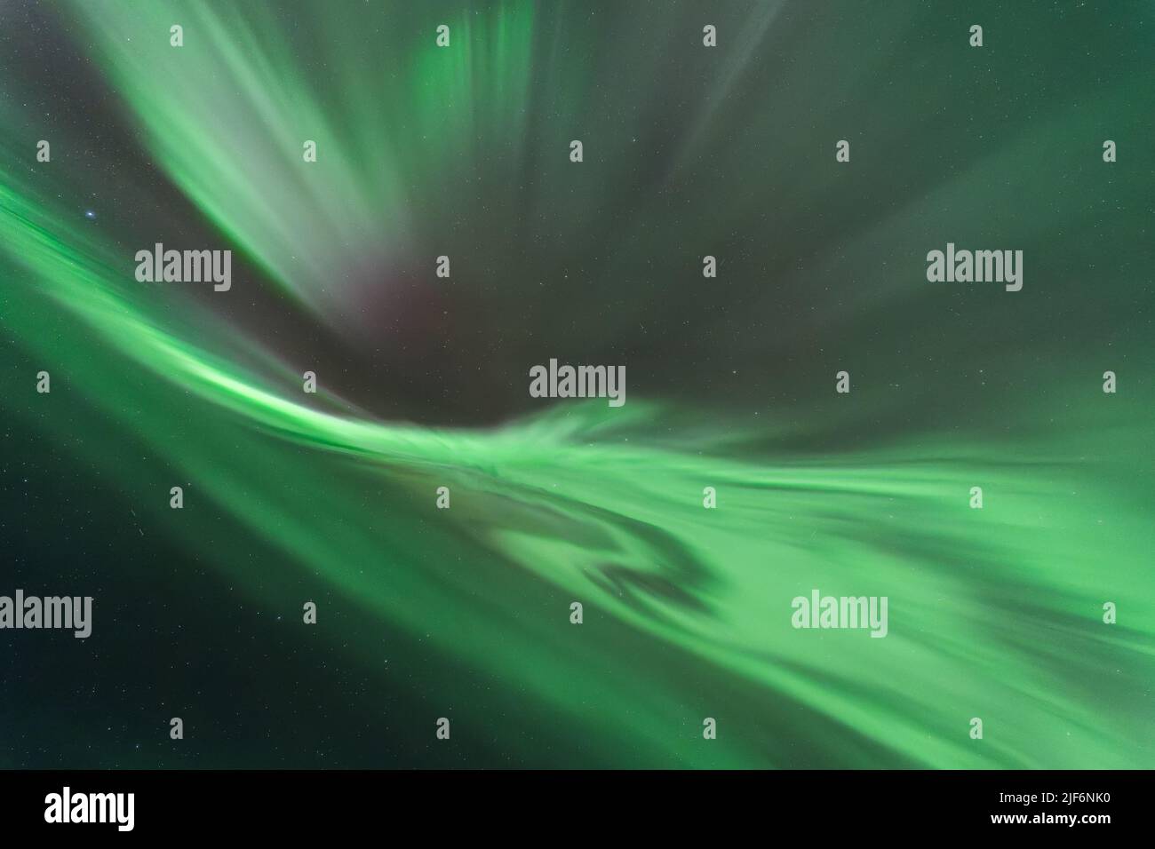 Spectacular scenery of green Northern lights illuminating dark sky in ...