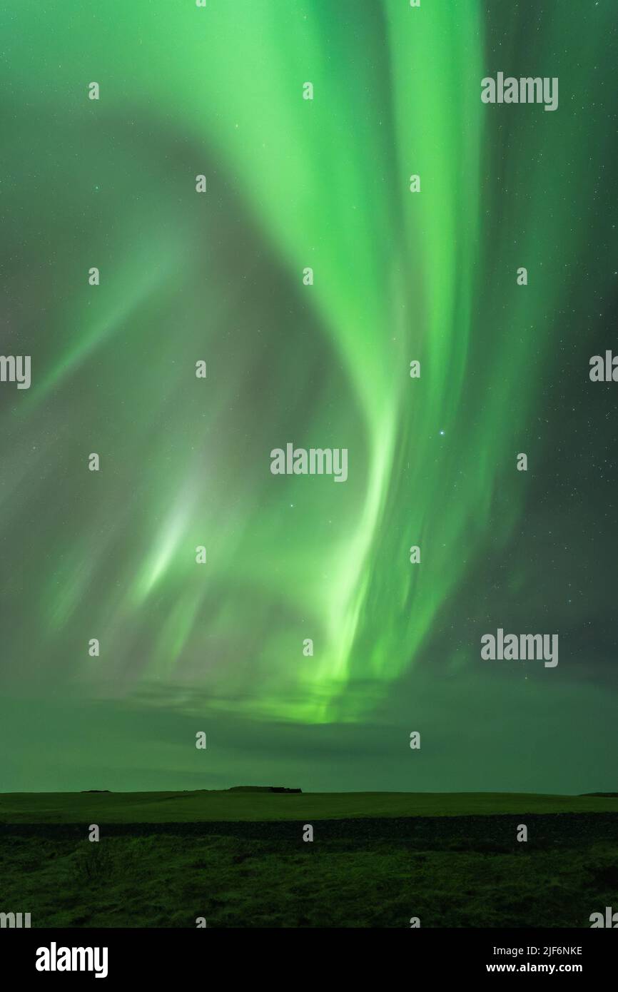 Spectacular scenery of green Northern lights illuminating dark sky in ...