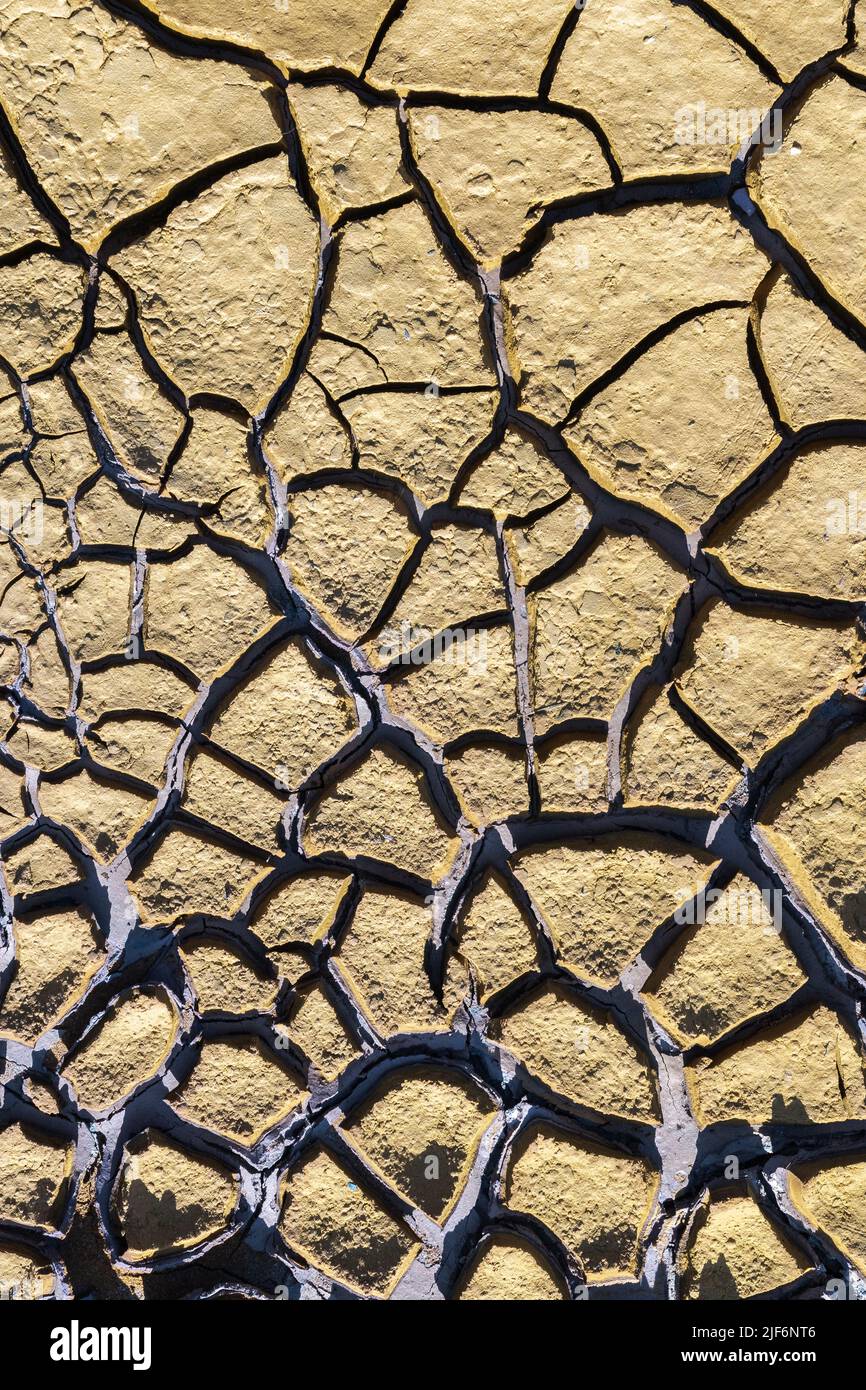 Full frame textured background of dry soil covered with cracks on sunny ...