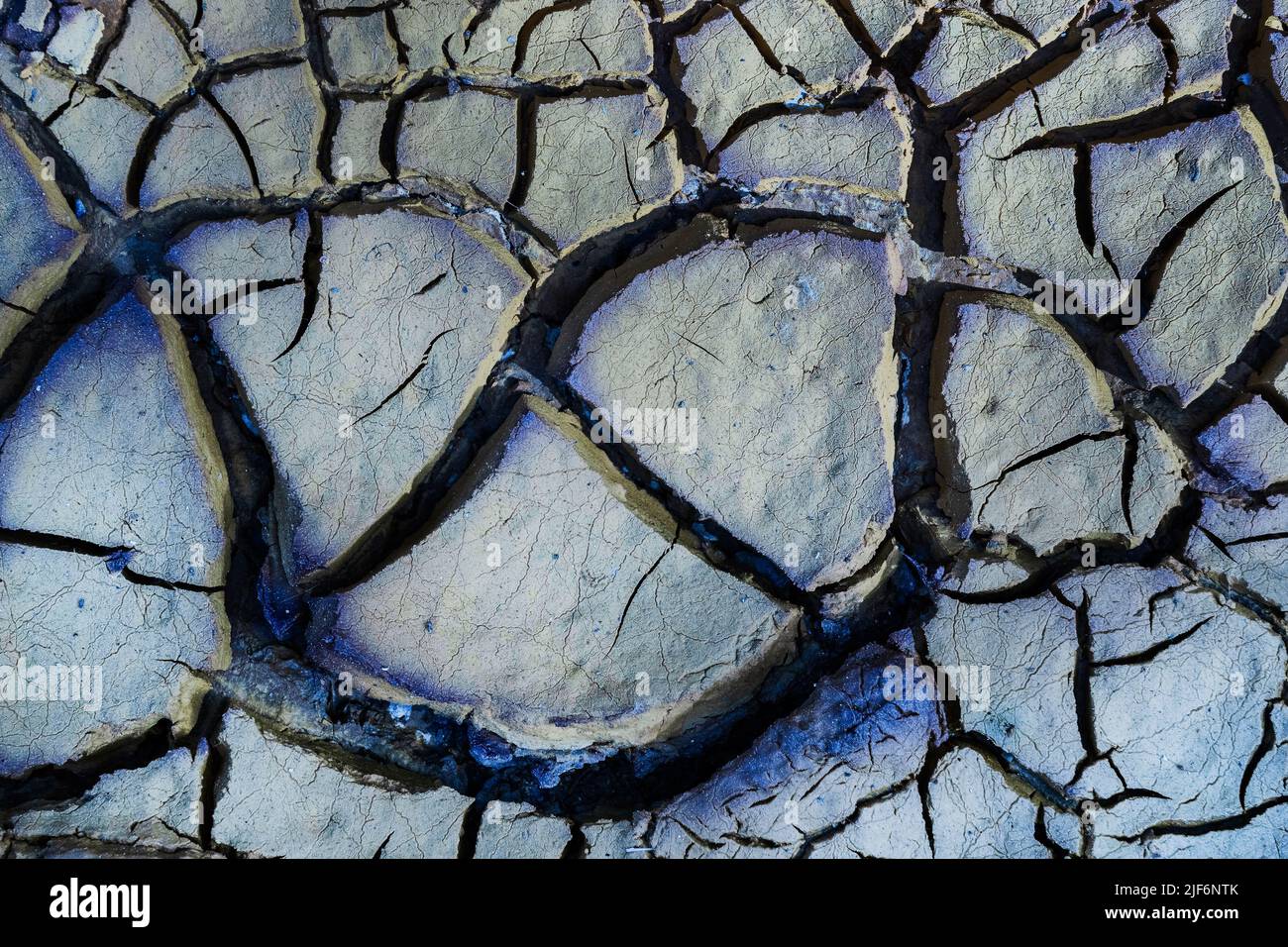 Full frame textured background of dry soil covered with cracks on sunny ...