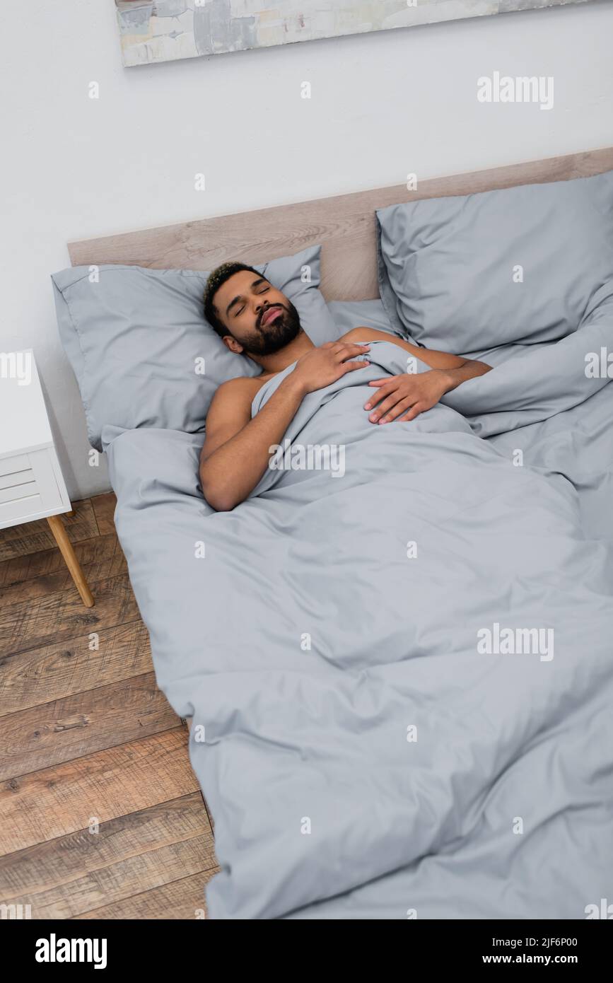 African american man sleeping in bed hi-res stock photography and ...