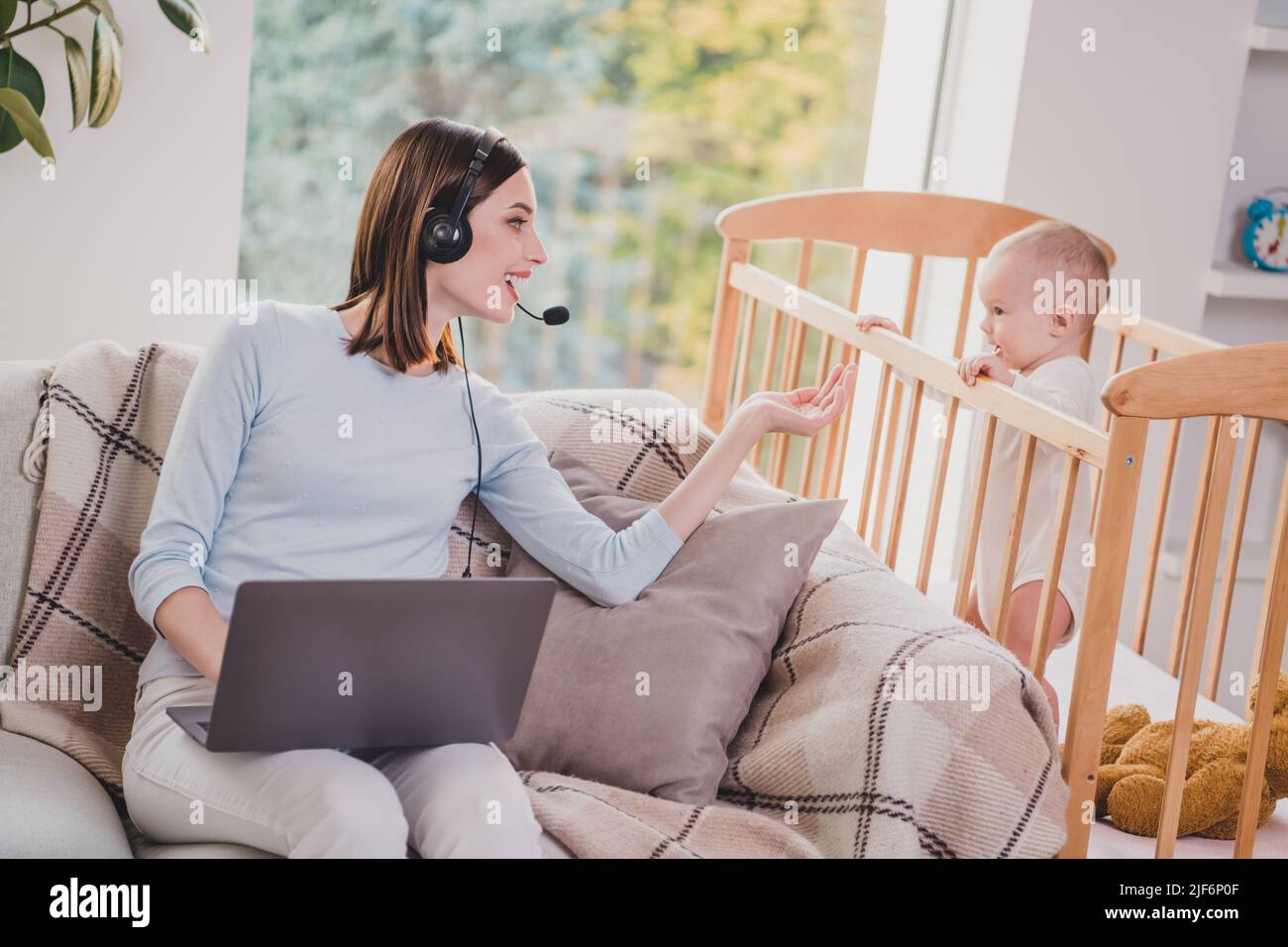 Portrait of attractive cheerful mom working remotely distance playing ...