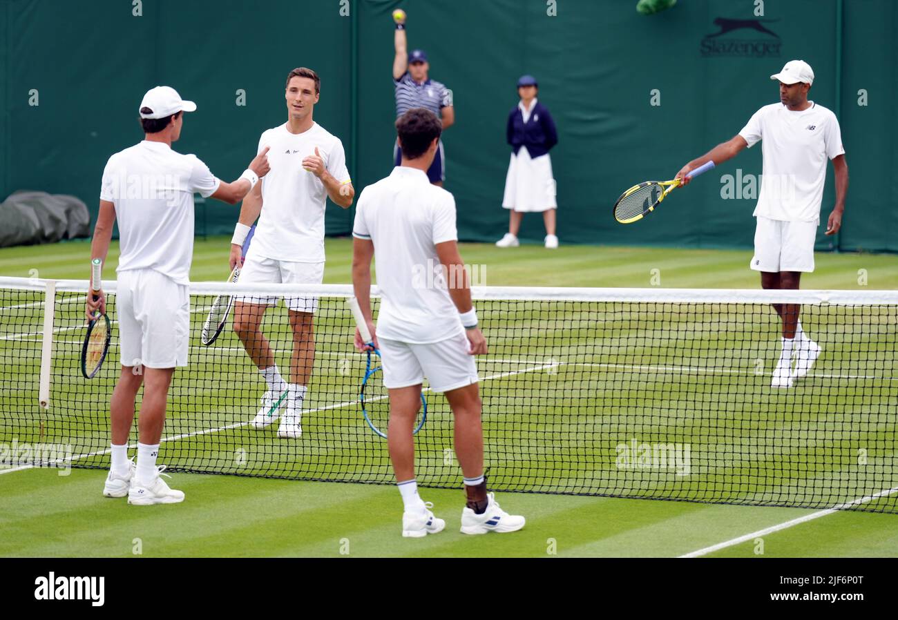 Joe Salisbury (second left) and Rajeev Ram in action during their ...