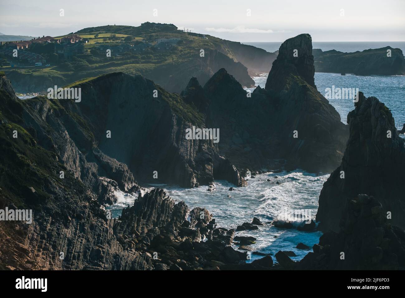 Scenic view of sea and mountains with houses on cliff in distant Stock ...