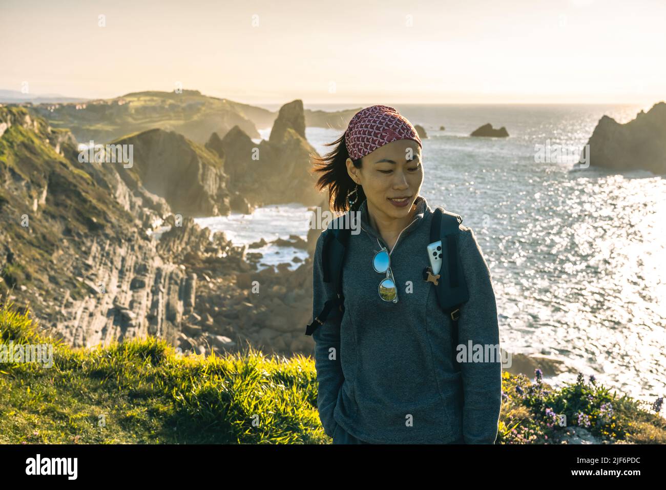 Elderly male doctor in earbud showing medications while talking on ...