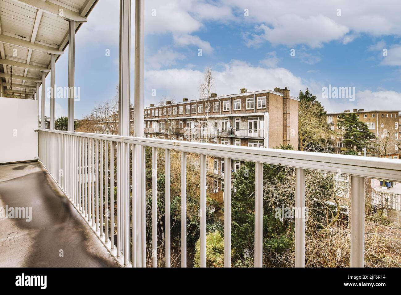 Narrow brick balcony with metal railings and door Stock Photo - Alamy