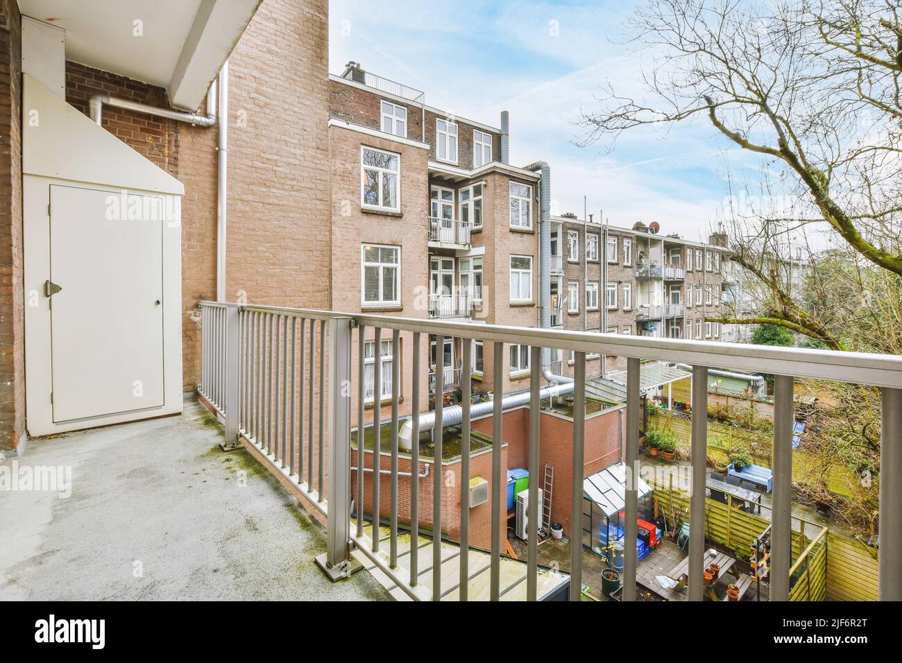 Narrow brick balcony with metal railings and door Stock Photo - Alamy