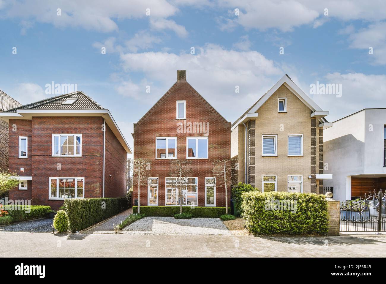 The front view of a brick building with signs, pavement and wooden ...