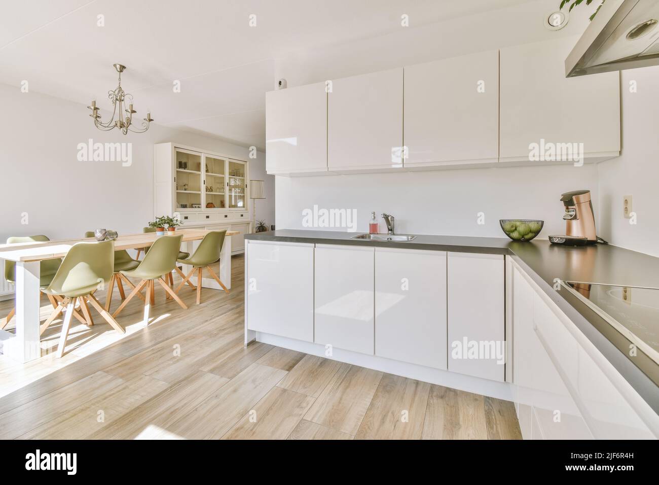 interior of light narrow home kitchen with minimalist style white ...