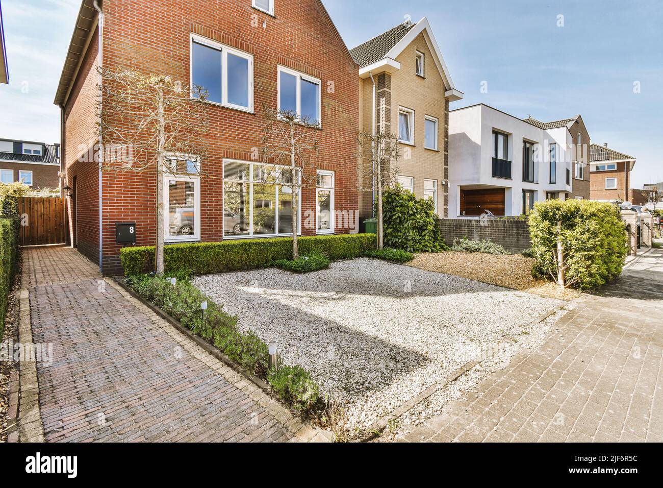 The front view of a brick building with signs, pavement and wooden ...