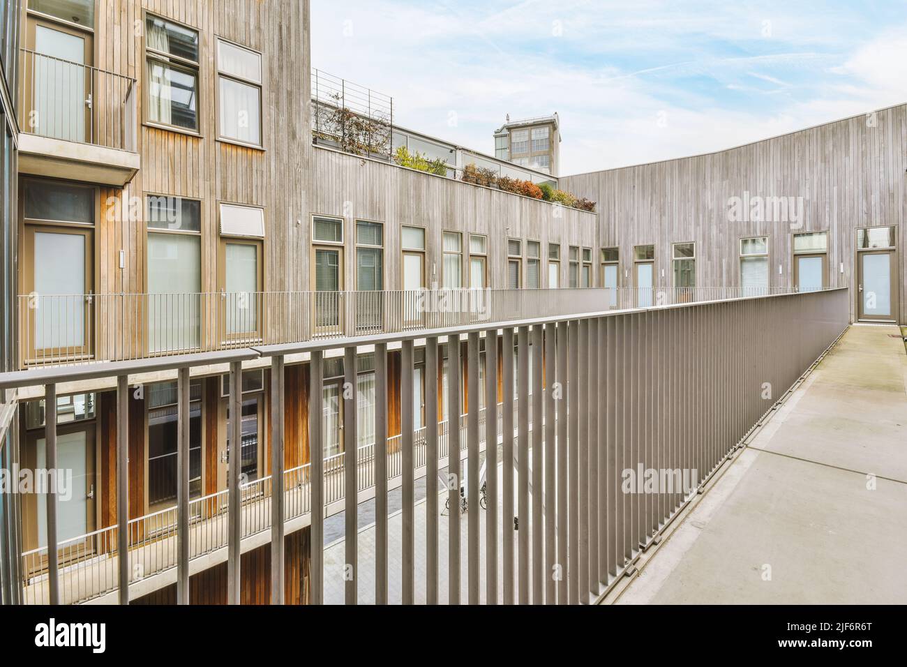 Long balcony with metal railing outside contemporary residential ...
