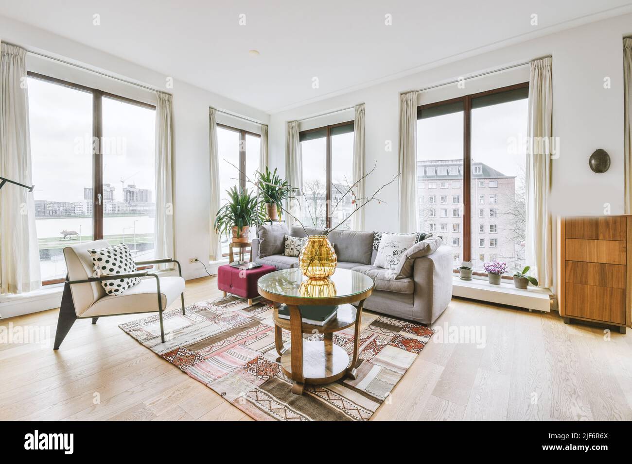 Interior of spacious open space room with lounge and dining zones in ...