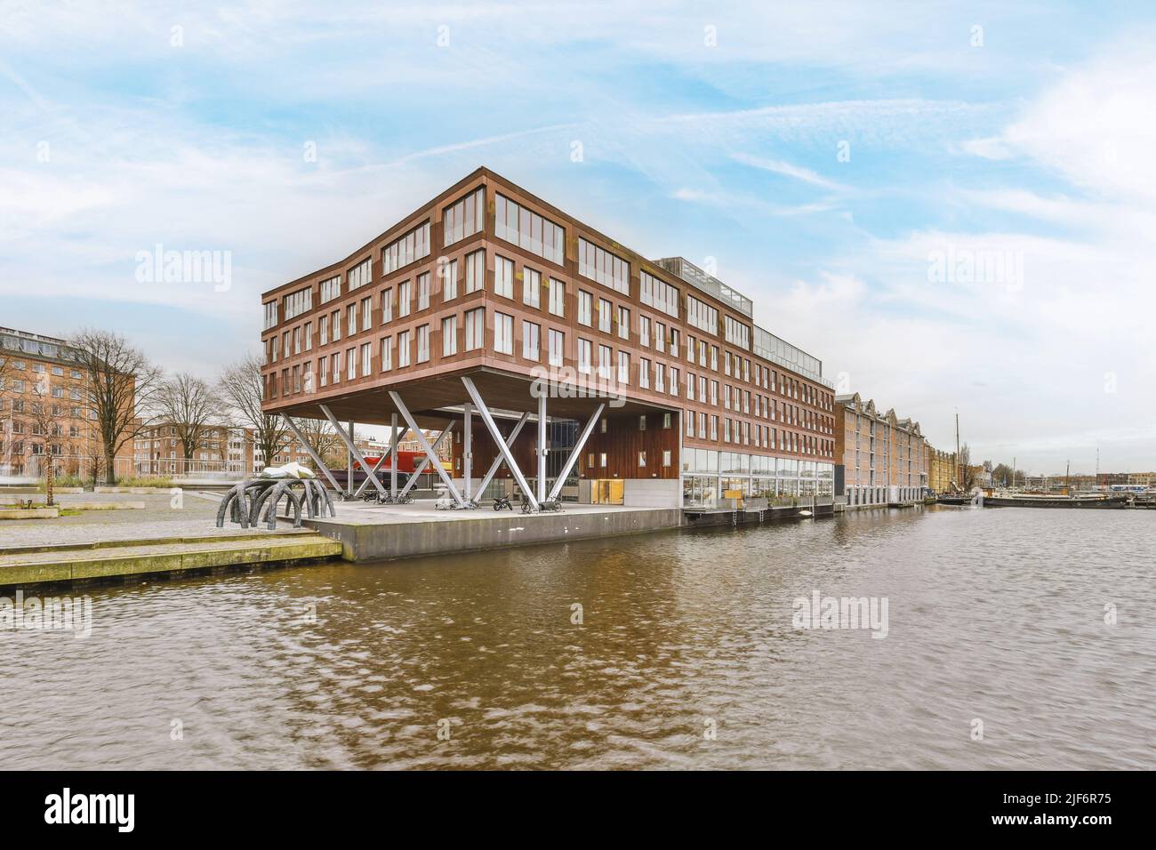 Contemporary residential building located on shore of canal with ...