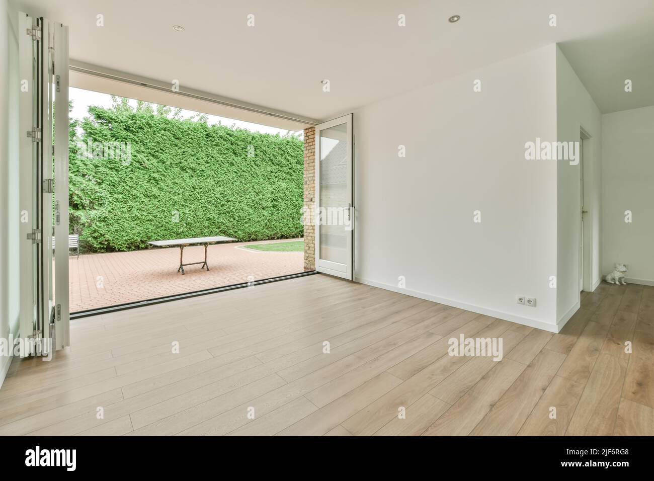 Spacious empty room in light apartment with opened glass doors leading ...