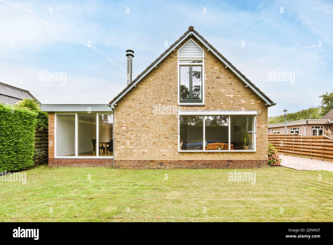 Patio of residential building terrace with grassy lawn in countryside ...