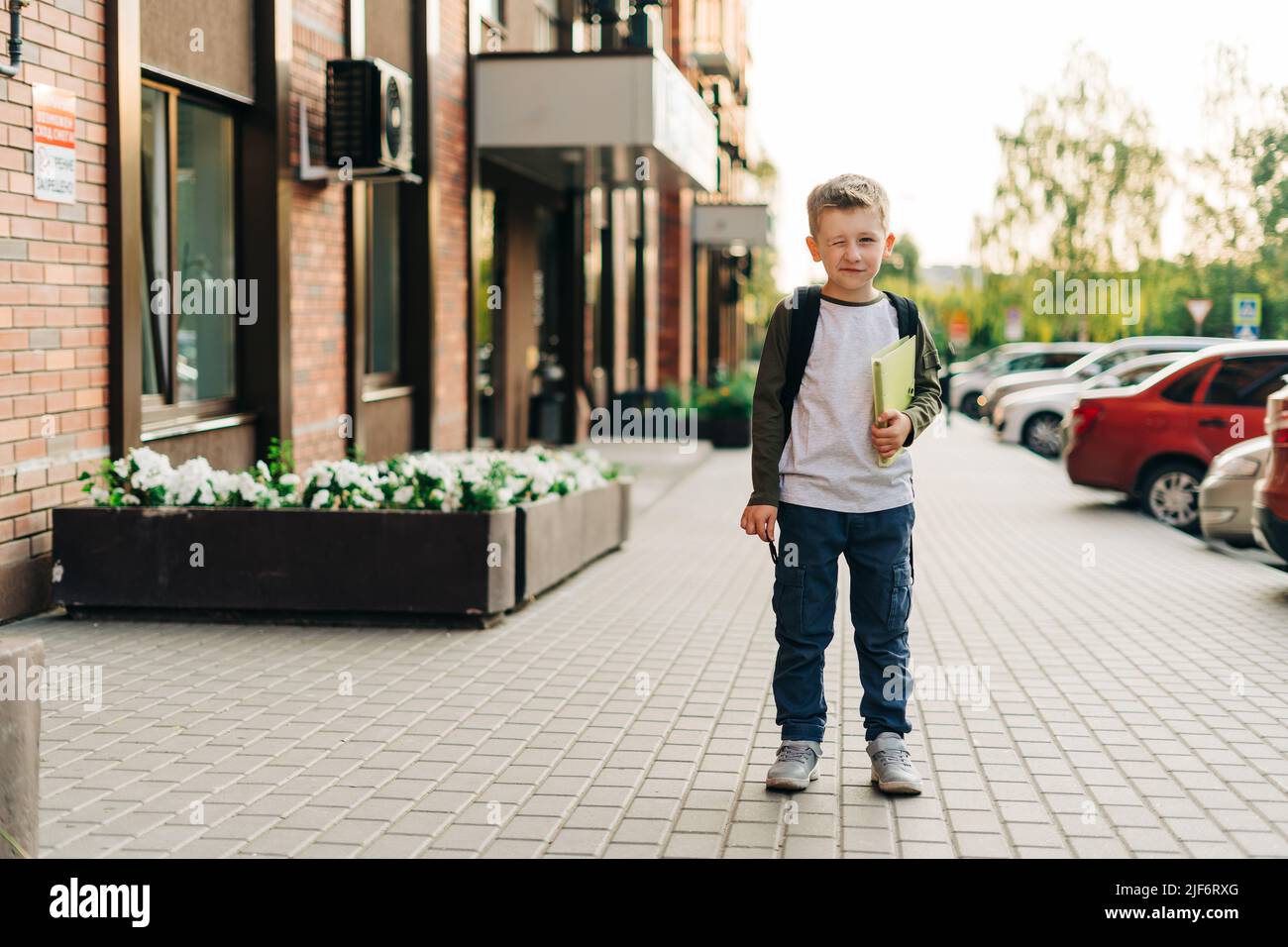 Back to school. Funny child with backpack holding notepad and training ...