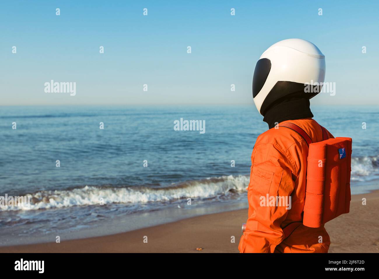 Side view of astronaut in futuristic spacesuit and helmet standing on ...