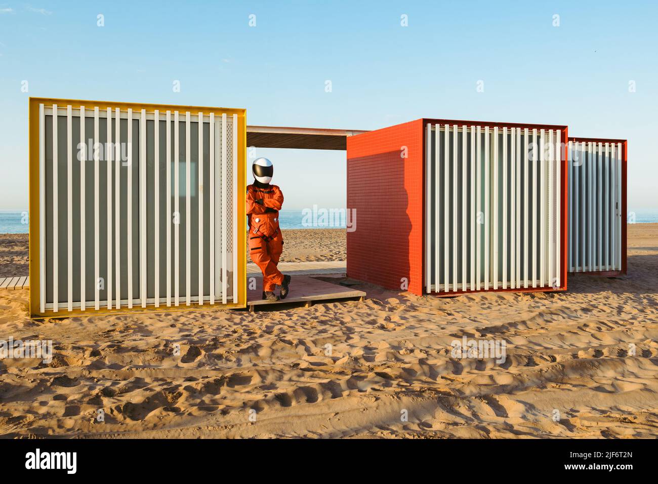 Back view of astronaut in spacesuit and helmet standing with arms ...