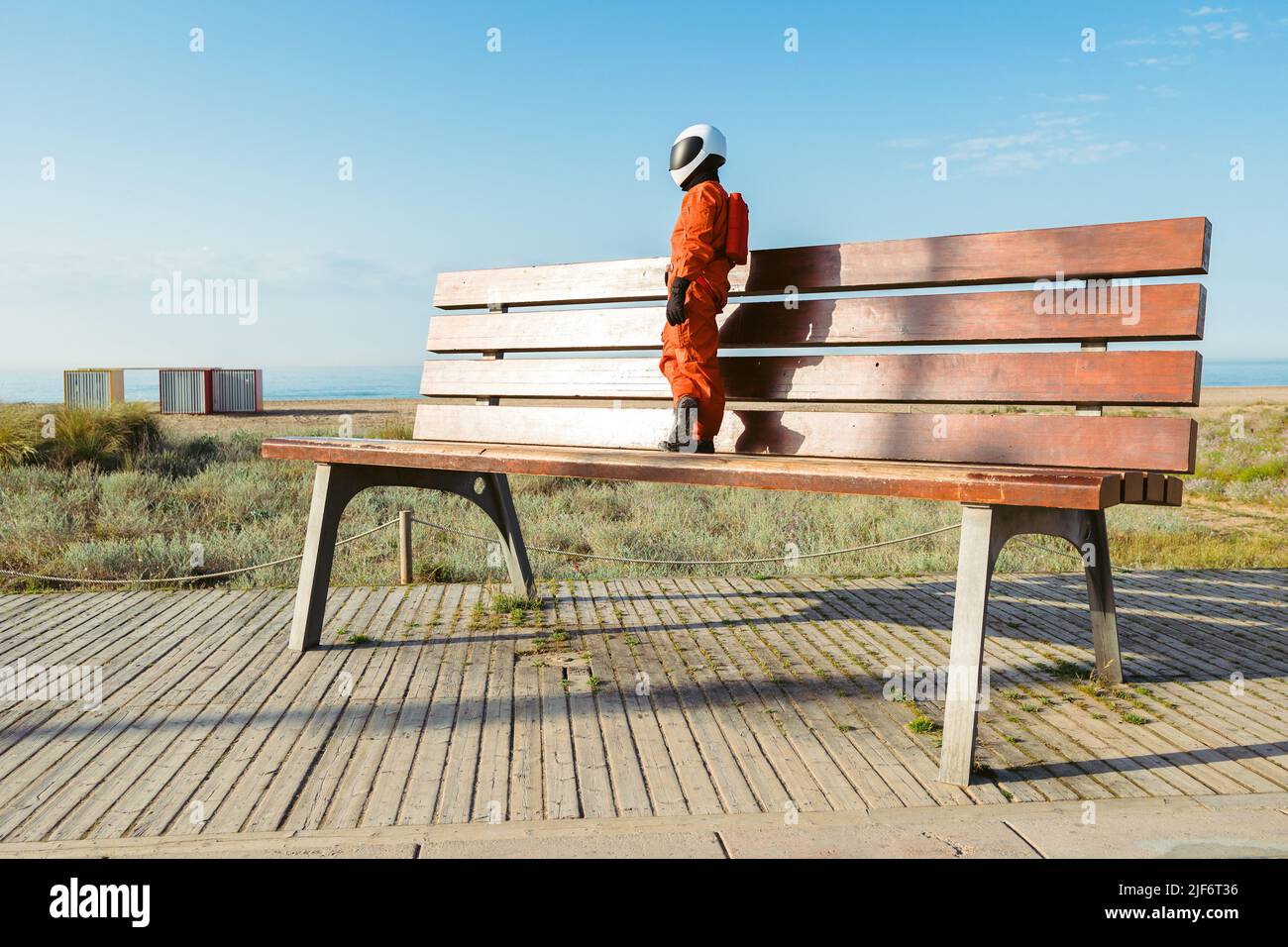 Full body astronaut in sci fi spacesuit and helmet standing on large ...