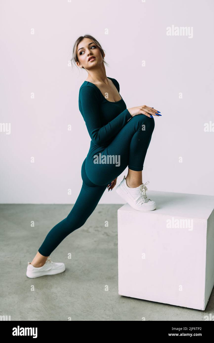 well-built sweaty girl doing box jump at sport center. full length side ...