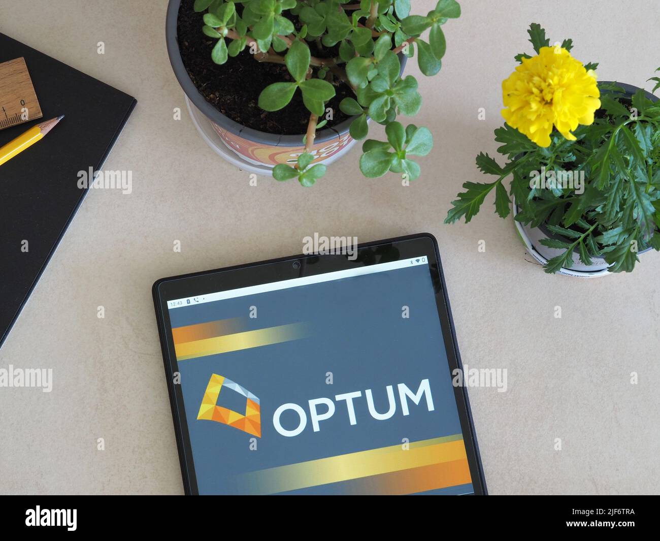In this photo illustration Optum, Inc. logo seen displayed on a tablet Stock Photo - Alamy