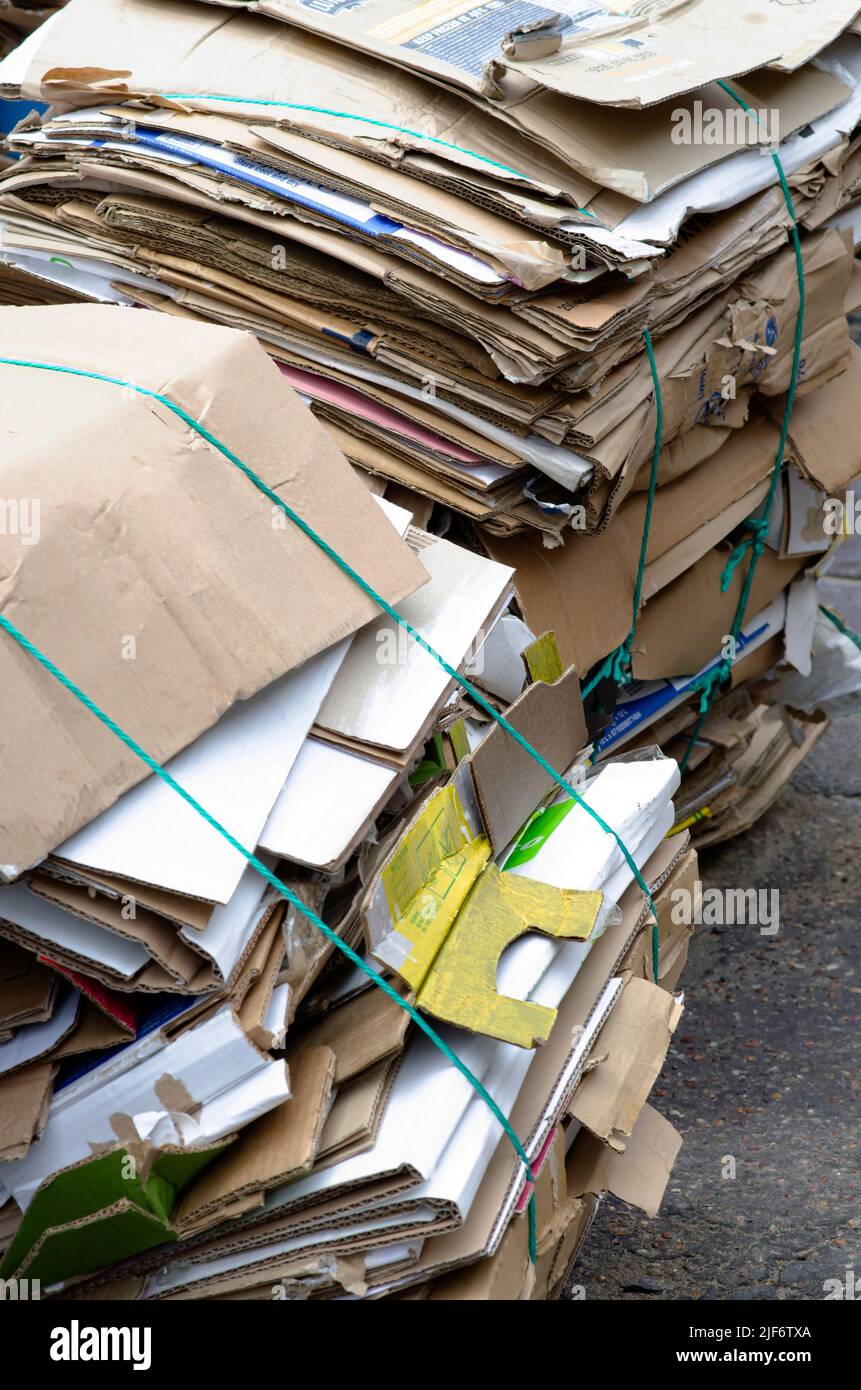 Bound bundles of cardboard boxes tied with strin Stock Photo - Alamy