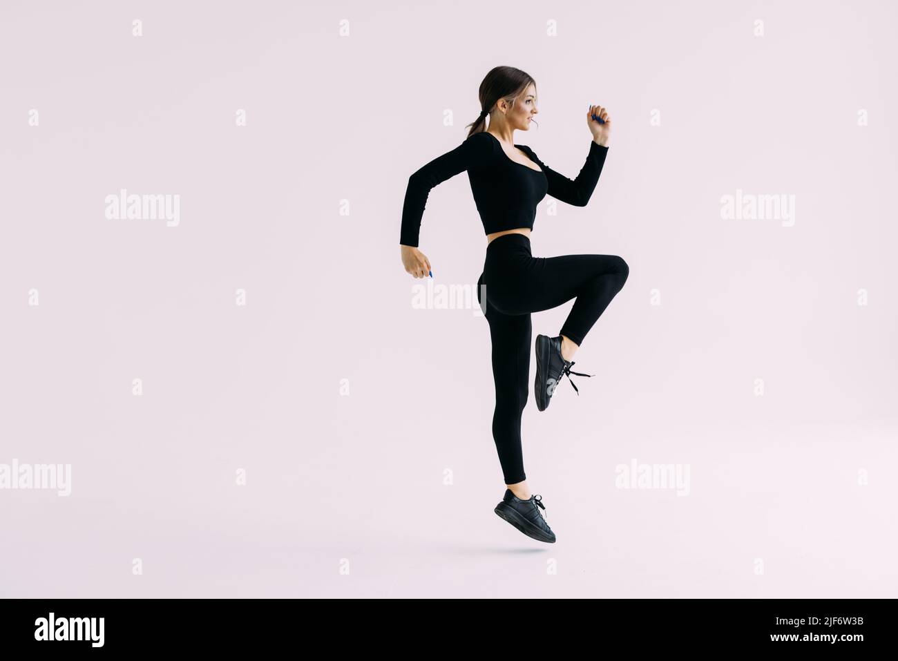 Full length portrait of a smiling fitness woman s working out isolated ...