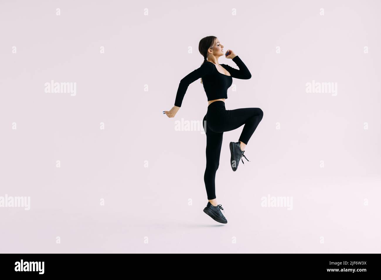 Full length portrait of a smiling fitness woman s working out isolated ...