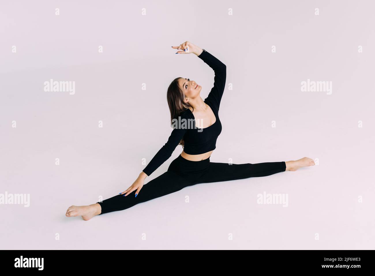 Fitness woman leg split on white background Stock Photo - Alamy