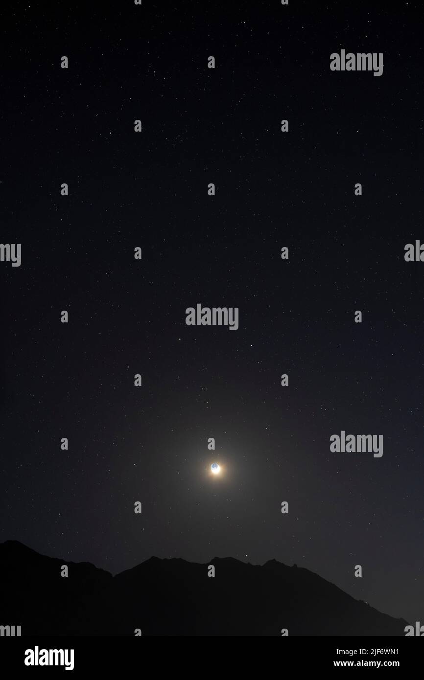 A view of the hills and the starry sky at night Stock Photo - Alamy