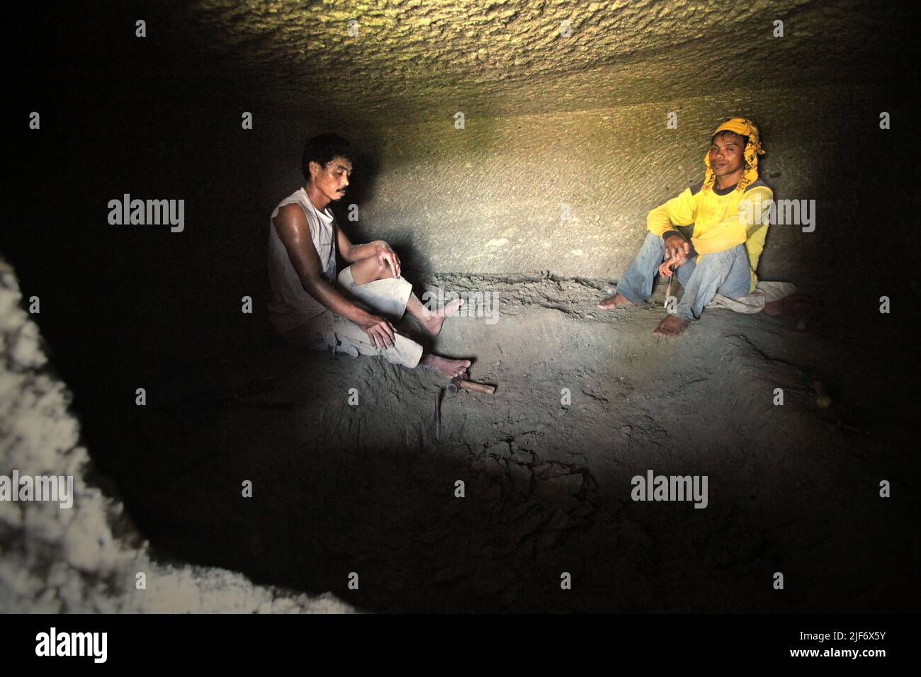 Workers are photographed as they are resting from digging and carving ...