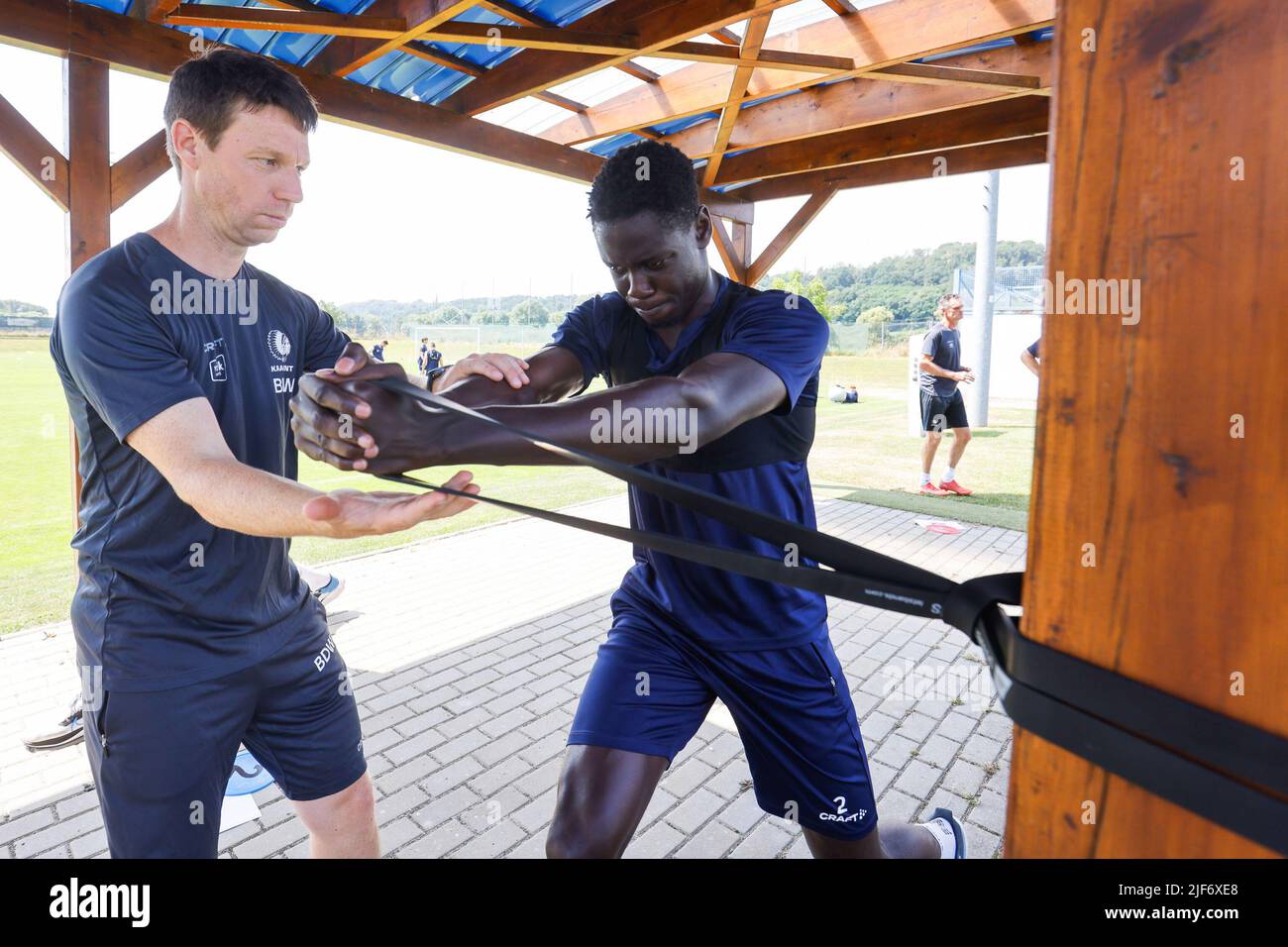 Gent's physical coach Bram De Winne (BDW) and Gent's Joseph Okumu pictured during a training ...