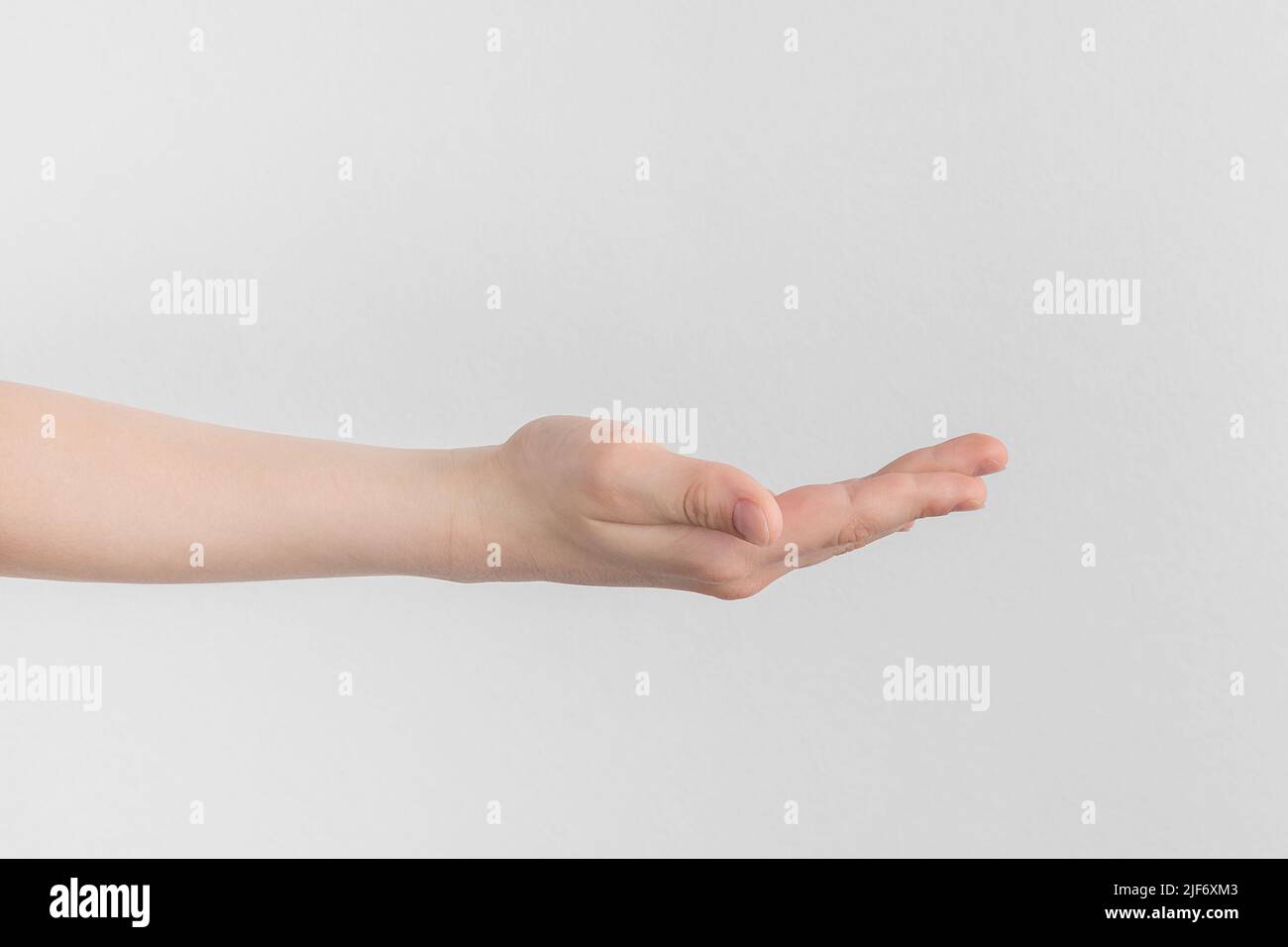 child hand palm up. side view Isolated on a white anf gray background ...