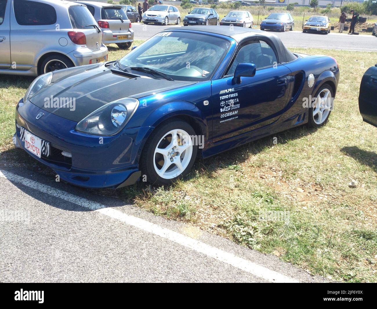 Little blue japan sports car parked in the field of the track. Toyota ...