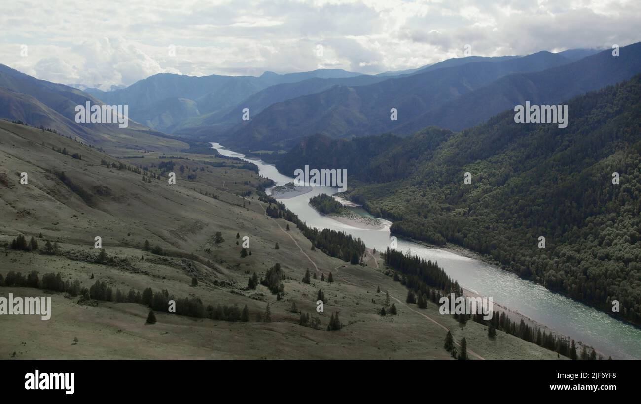 River Katun between mountains of Ak-Kem valley under white clouds in ...