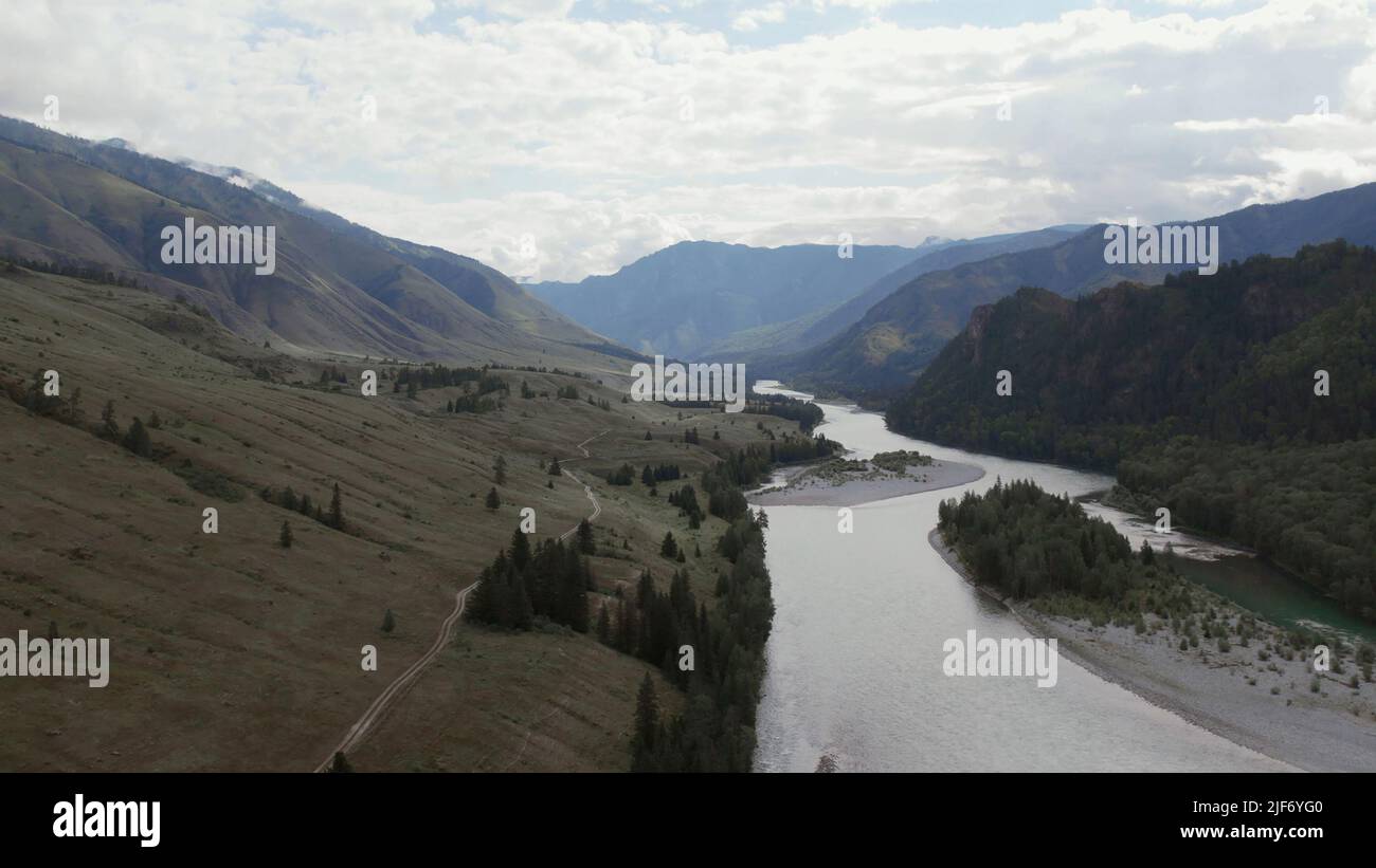 River Katun between mountains of Ak-Kem valley under white clouds in ...