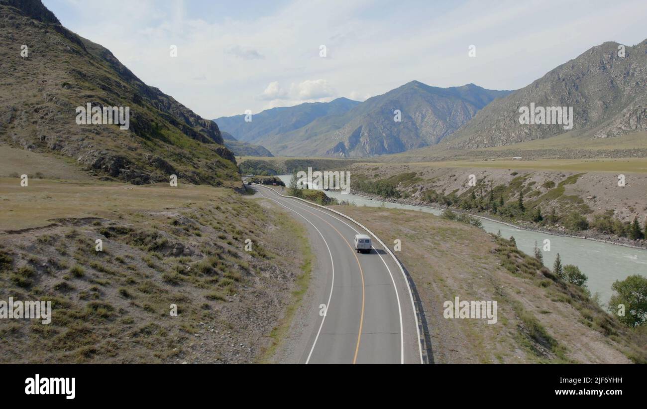 Traffic cars on Chuya highway road between mountains and Katun river in ...
